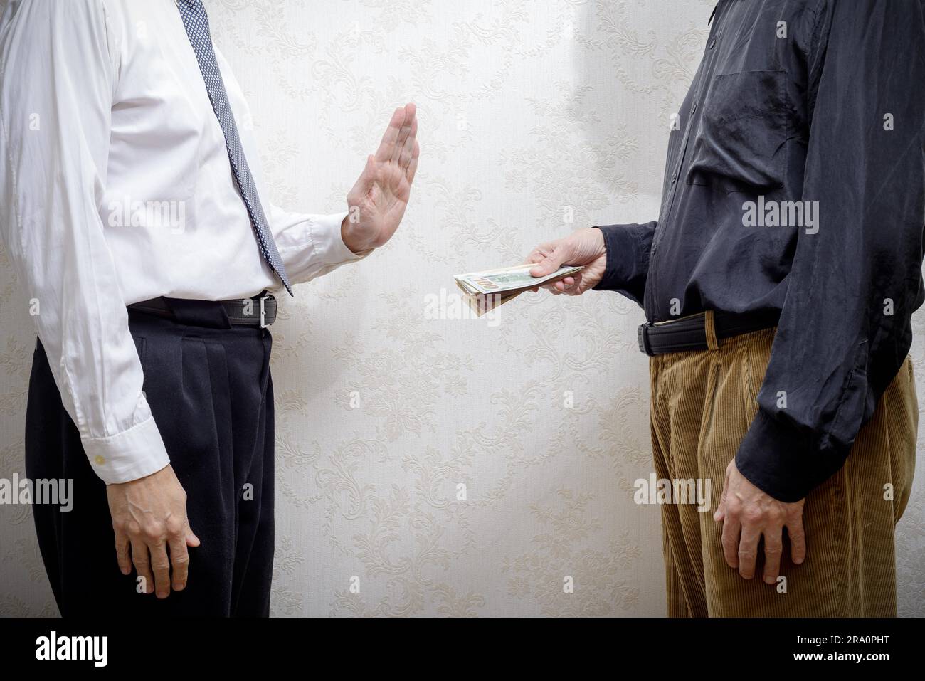 Corrupted man offering a Dollars banknotes bribe to a businessman, or ...