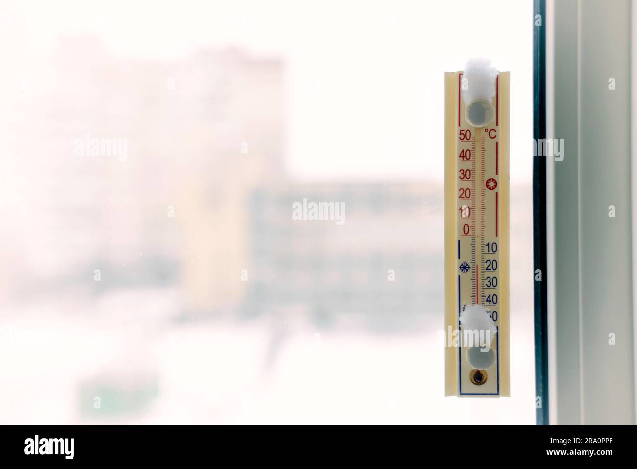 A thermometer, fixed out of the window, shows that it is minus ...