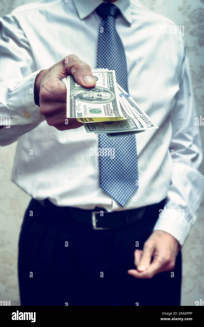 Corrupted businessman, or politician, offering a Dollar banknotes bribe ...