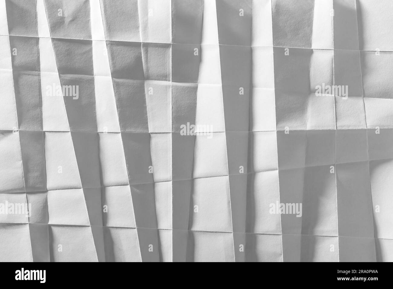 White folded sheet of paper showing an abstract texture design under ...