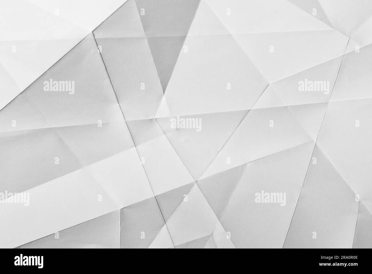 White folded sheet of paper showing an abstract texture design under ...
