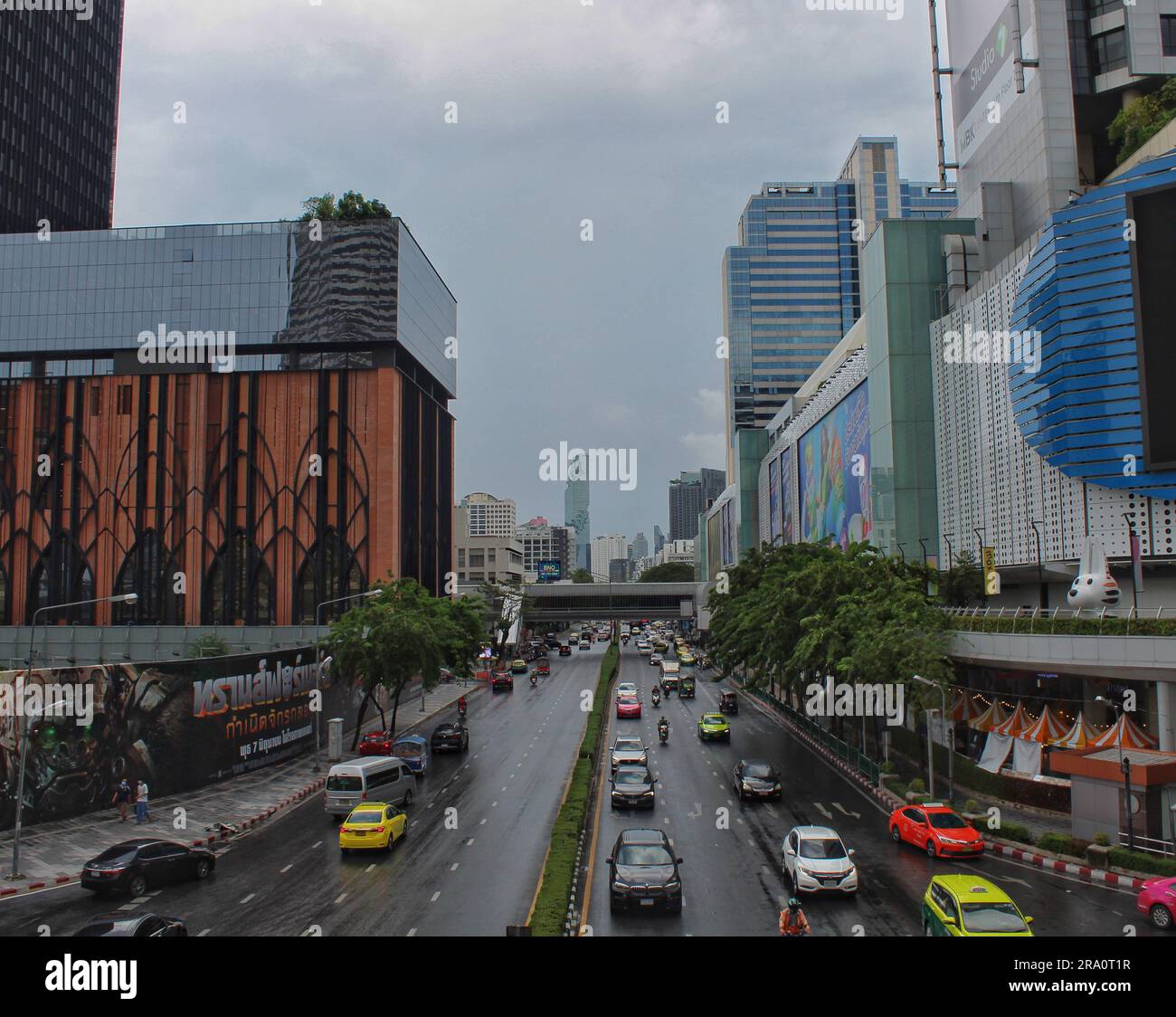 A landscape photo of a road with cars in Bangkok Thailand on a moist ...