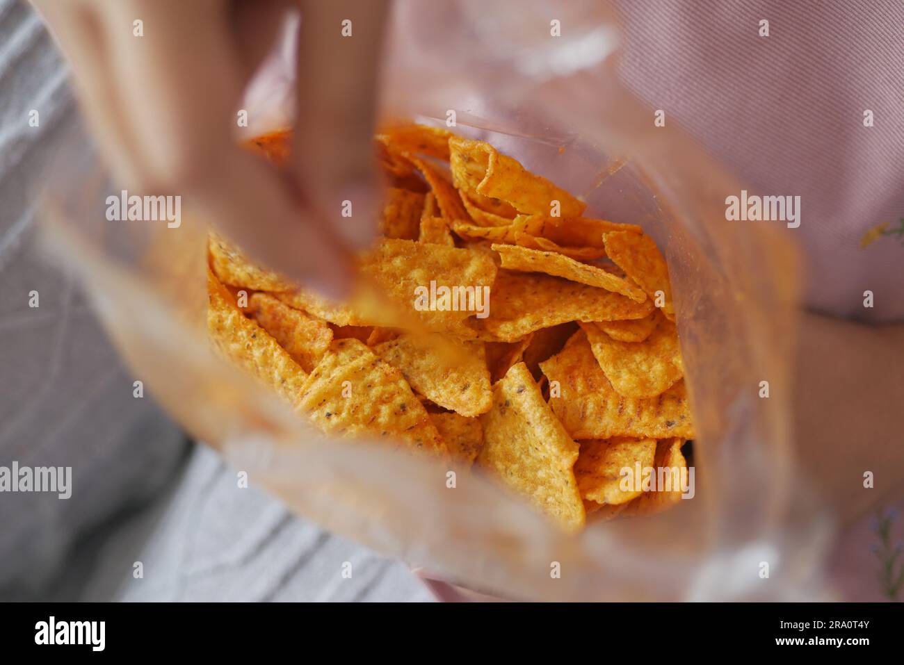 Holding packet of chips hi-res stock photography and images - Alamy