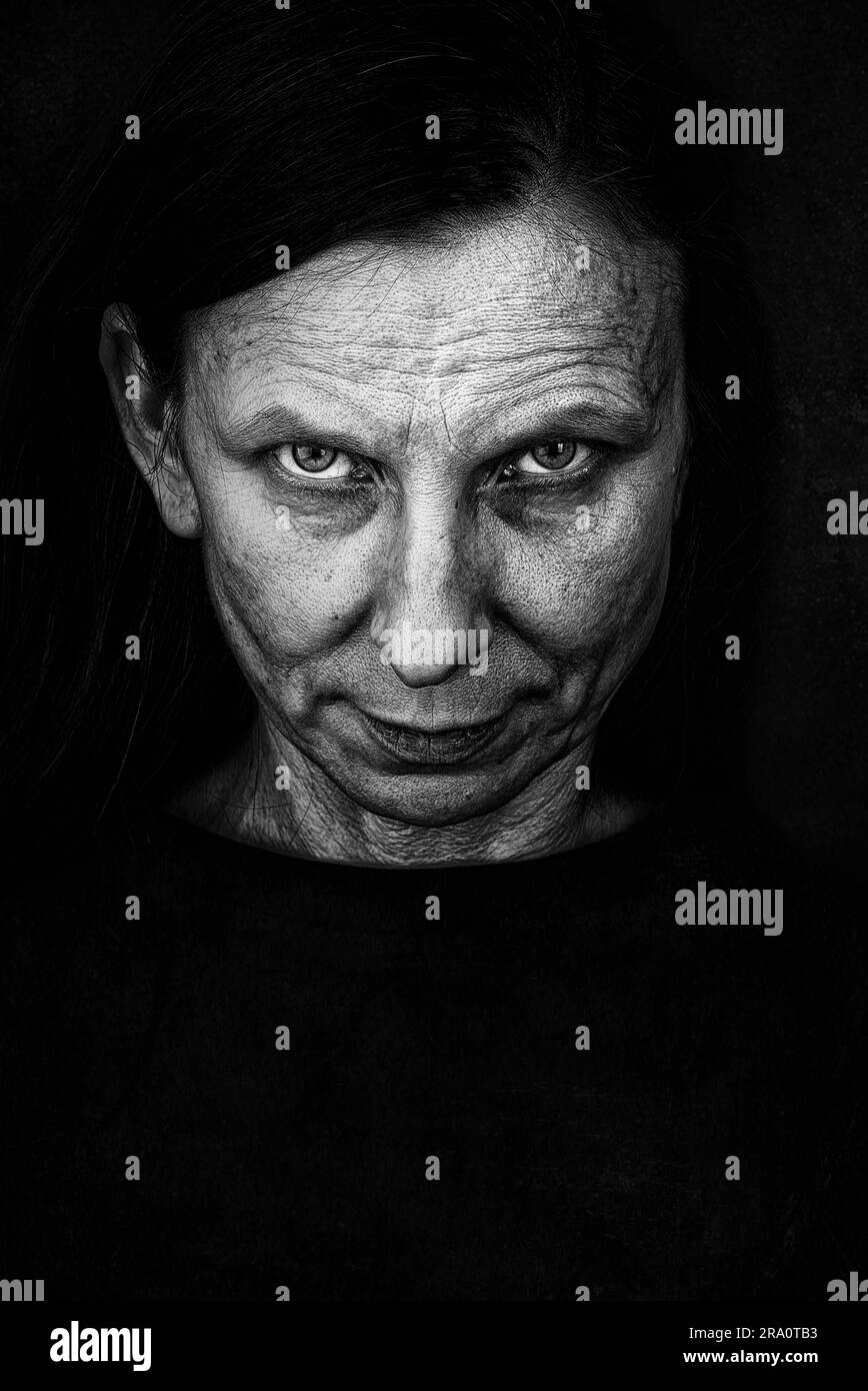 Mysterious portrait of a sneaky adult woman looking from down Stock ...