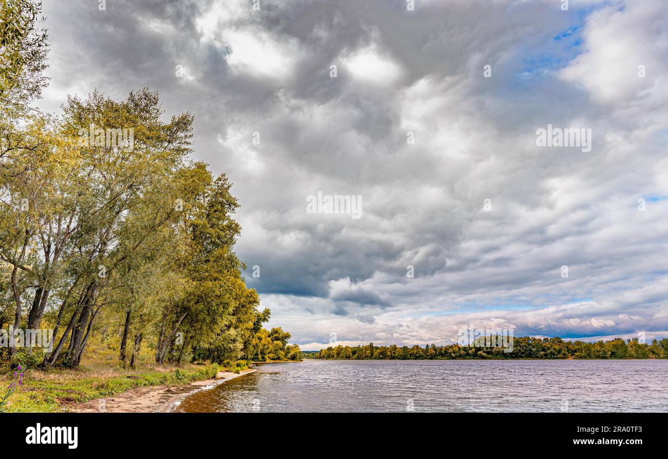 Heavy clouds in the sky over the Dnieper river announce the incoming of ...