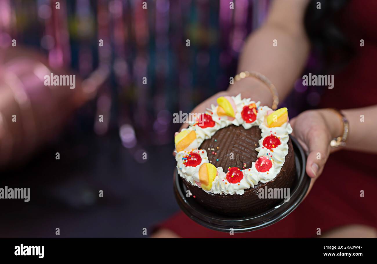 girl's hand holding a birthday cake Focus on the happy moments Stock ...