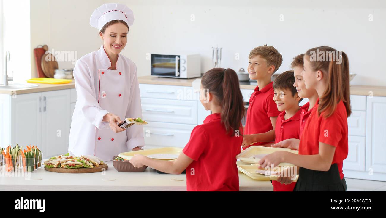 Group of pupils receiving lunch in school canteen Stock Photo - Alamy