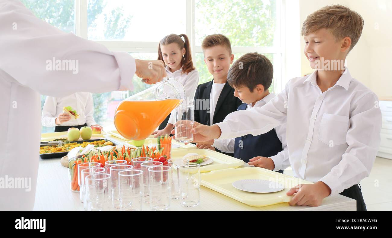 Group of pupils receiving lunch in school canteen Stock Photo - Alamy