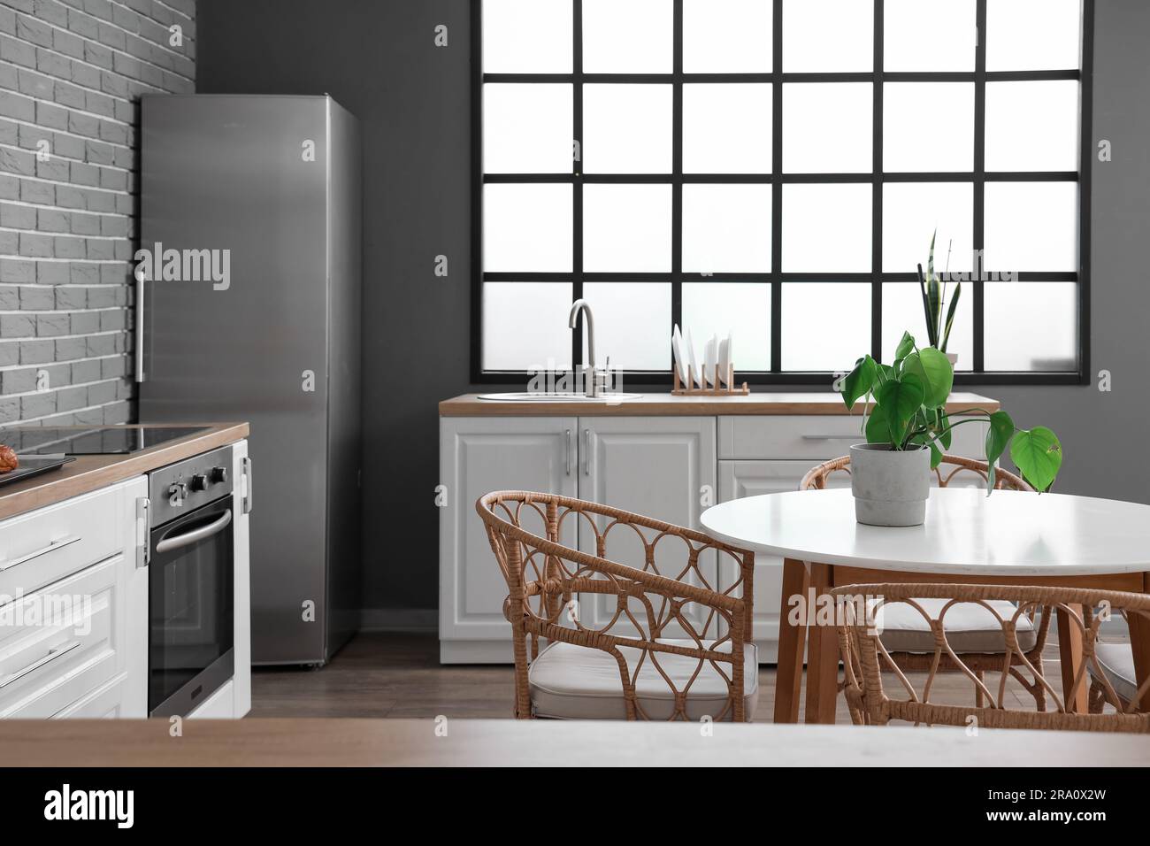 Interior of modern kitchen with dining table, stove and fridge Stock ...