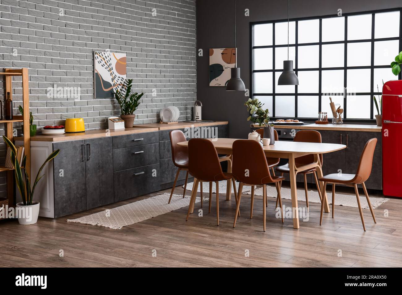 Interior of modern kitchen with dining table and grey counters Stock ...