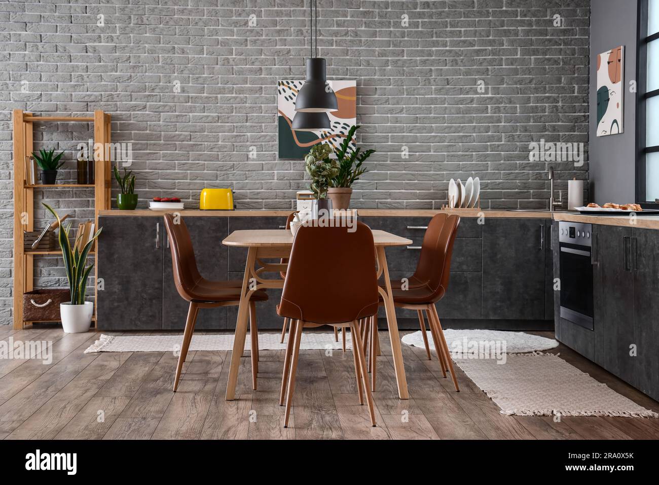 Interior of modern kitchen with dining table and grey counters Stock ...