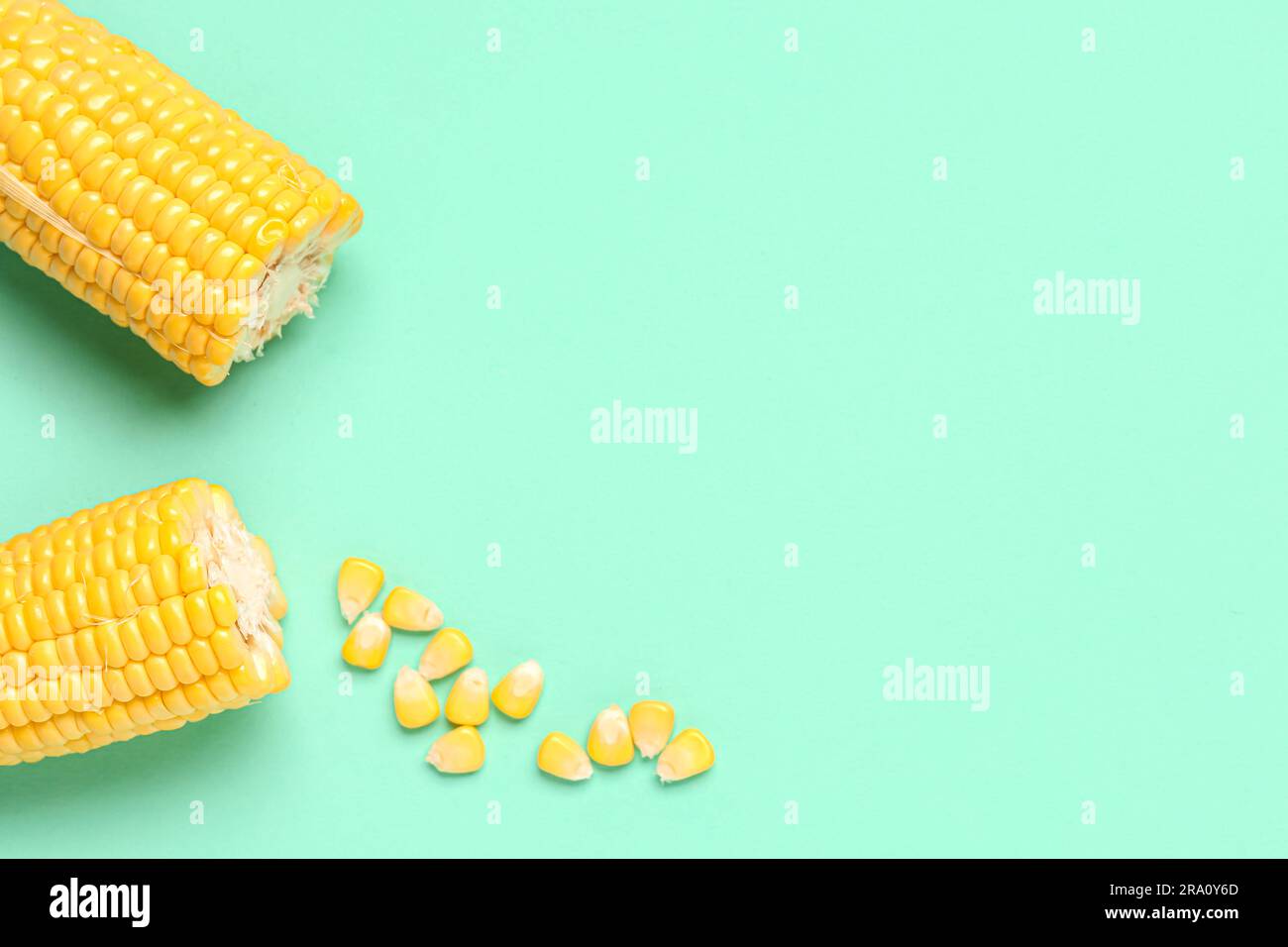 Cut fresh corn cobs and seeds on turquoise background Stock Photo - Alamy