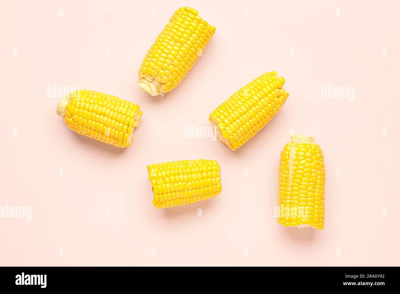 Cut fresh corn cobs on pink background Stock Photo - Alamy