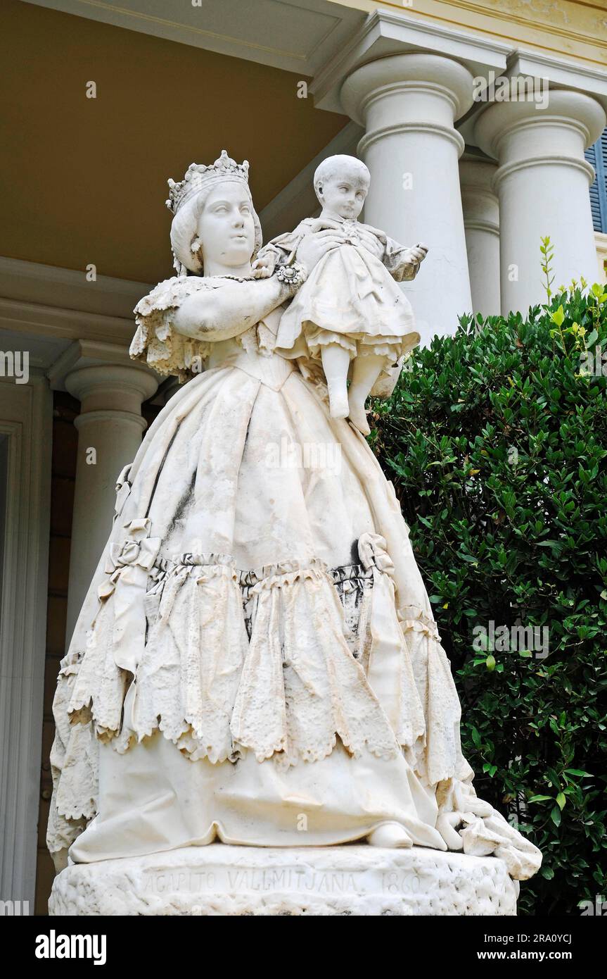 Statue of Queen Isabella II presenting her son Alfonso Xll, botanical ...