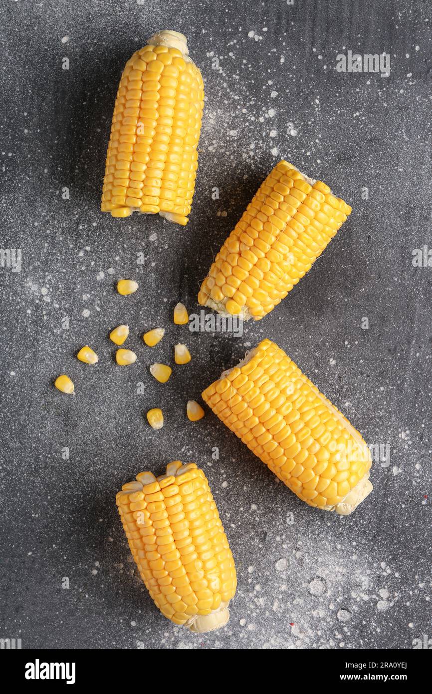 Cut fresh corn cobs and seeds on grey background Stock Photo - Alamy