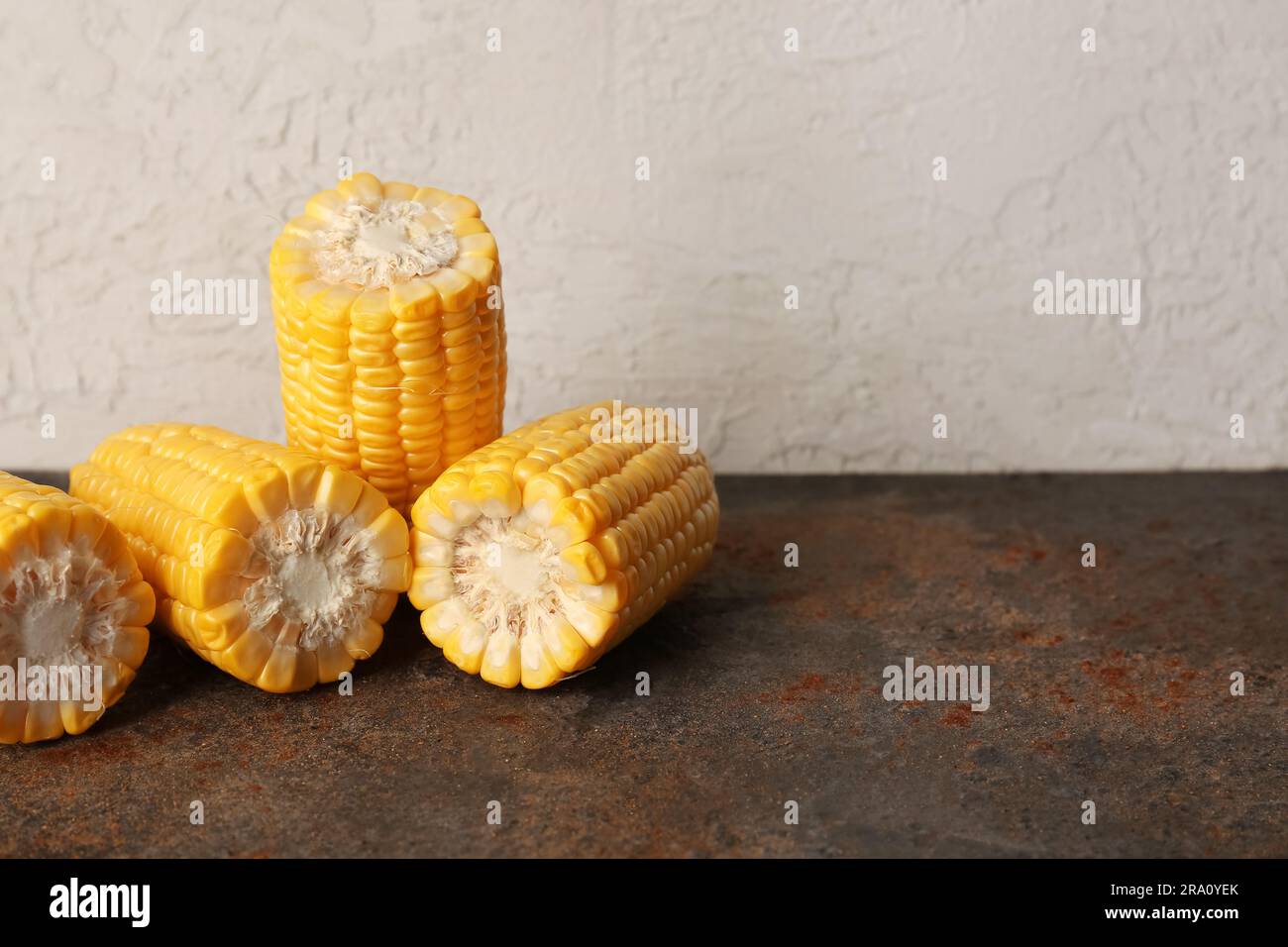 Cut fresh corn cobs on dark table Stock Photo - Alamy