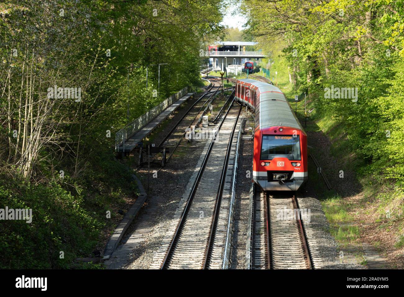Railway line in the green with moving train on the underground line U1 ...