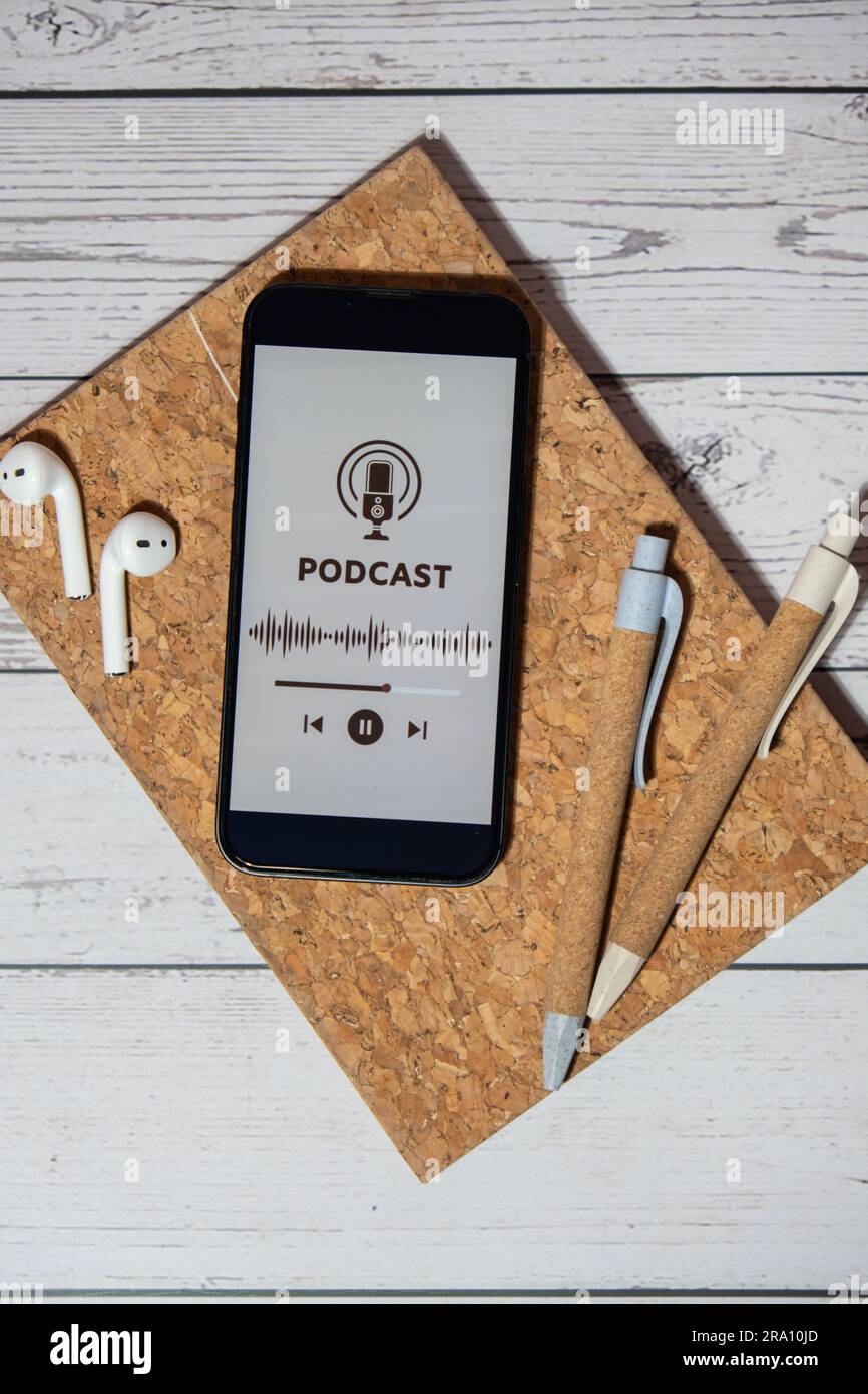 Paper notebook pens with wireless headphones and mobile phone Podcast ...