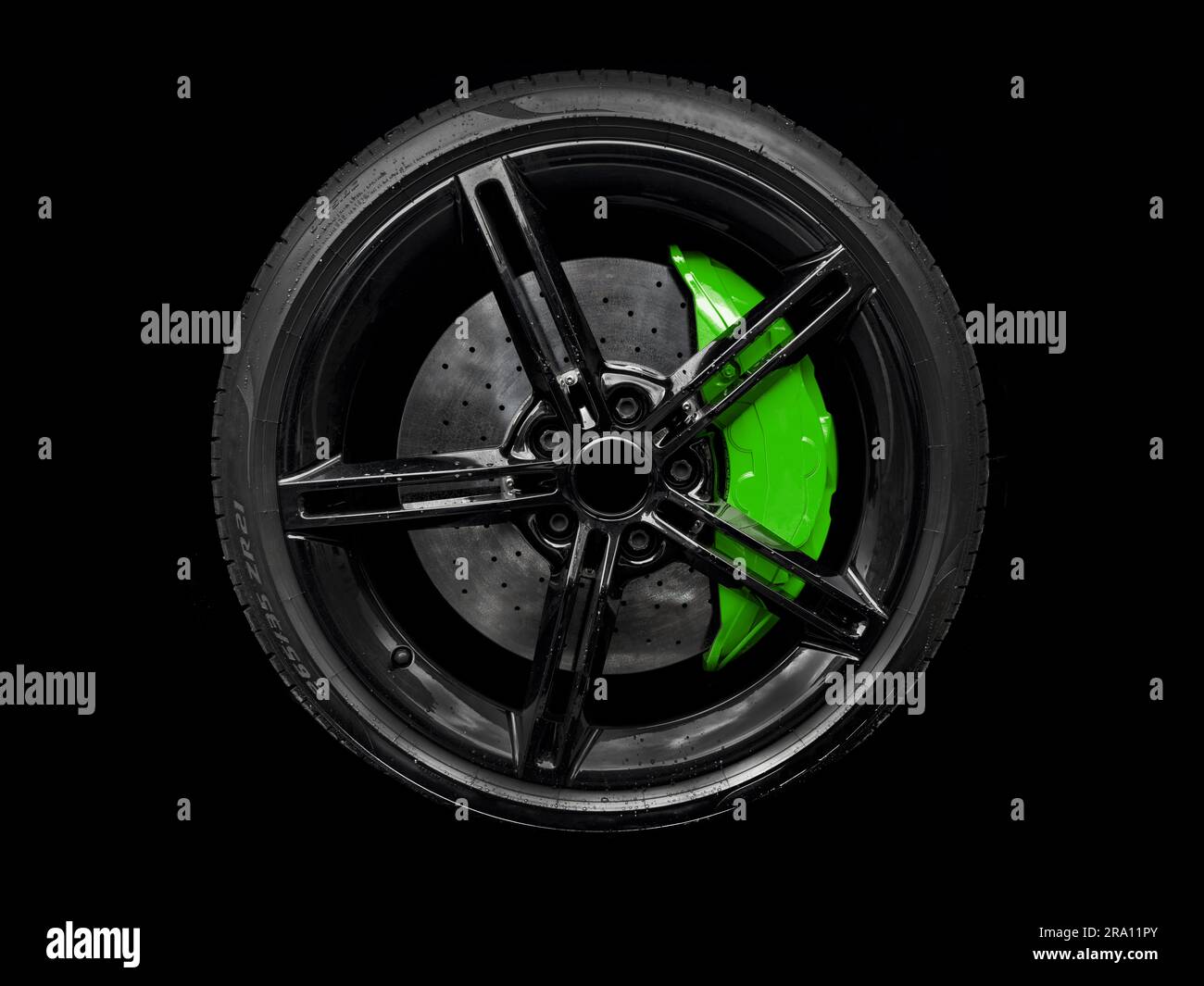Car alloy wheel and tyre isolated on black background. New alloy wheel ...