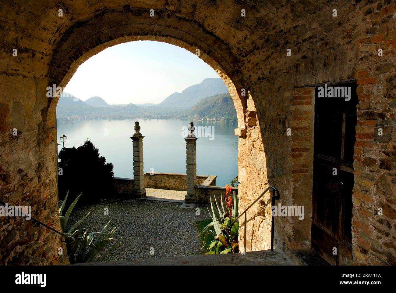 Archway of the pilgrimage church Maria del Sasso, view of Lake Lugano ...