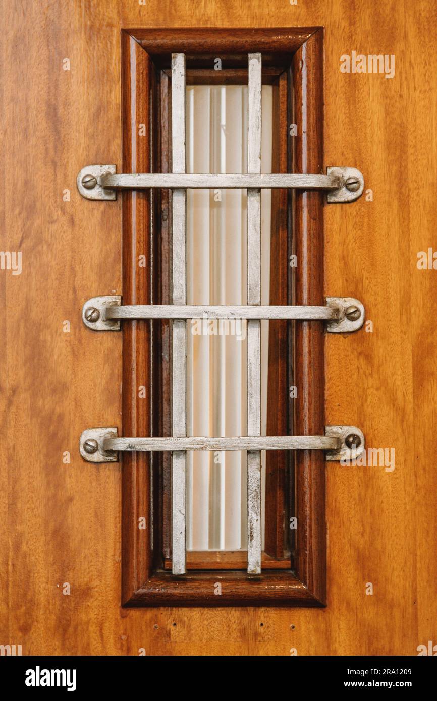 a wooden door with metal latches on the top and bottom bars attached to ...