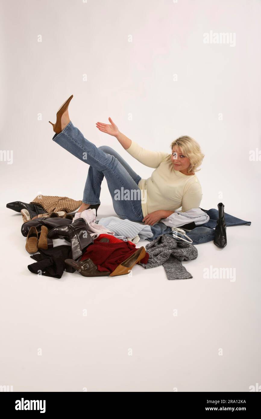 Woman pointing at shoe, between clothes and shoes, free space Stock ...