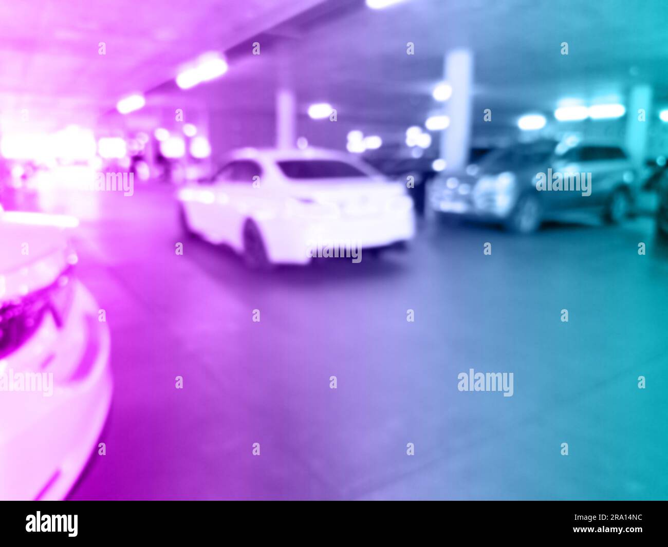 Blurred cars in car parking lot in shopping mall. Bokeh lights ...