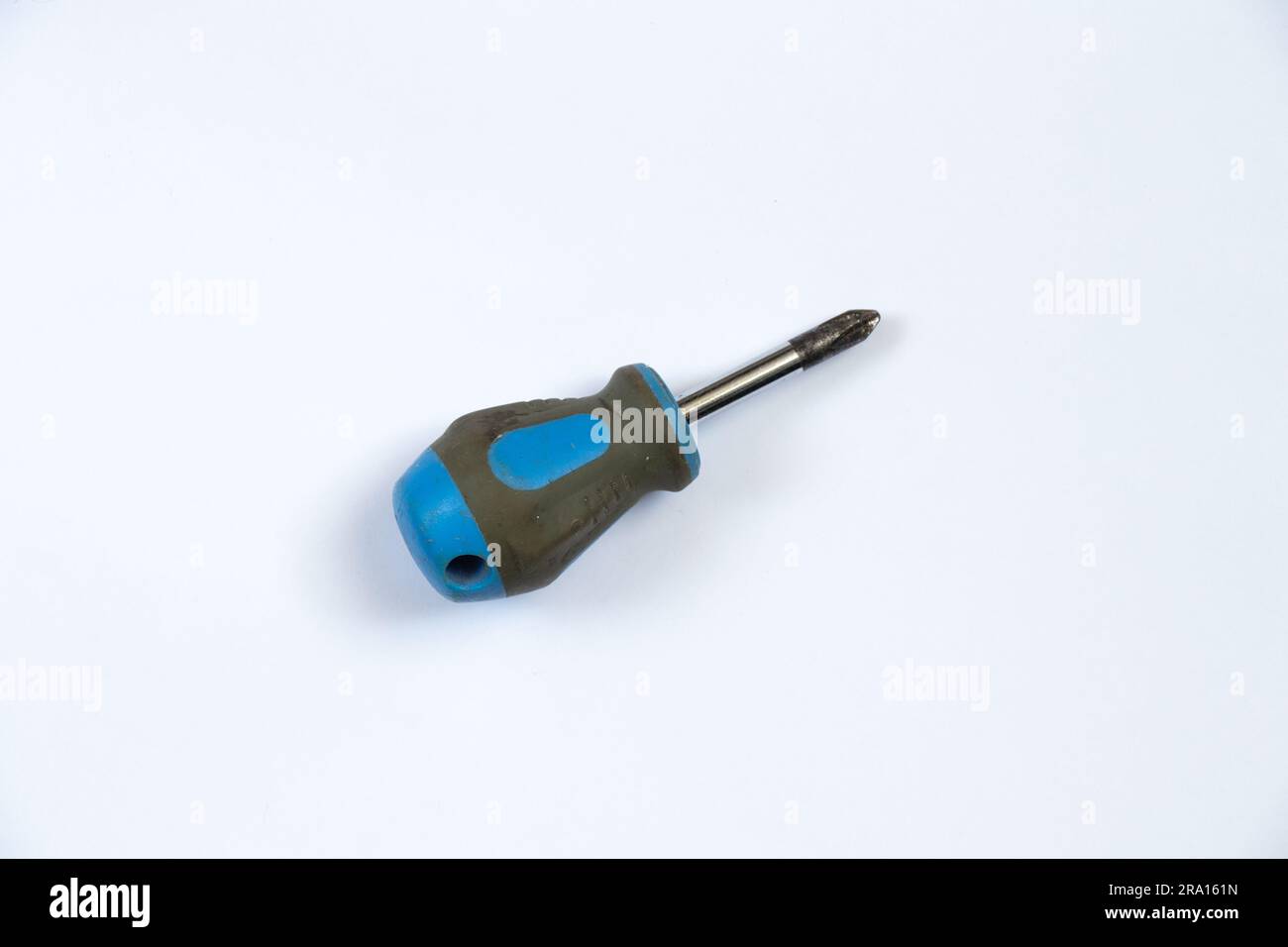 of a screwdriver with a blue handle on an isolated white background ...