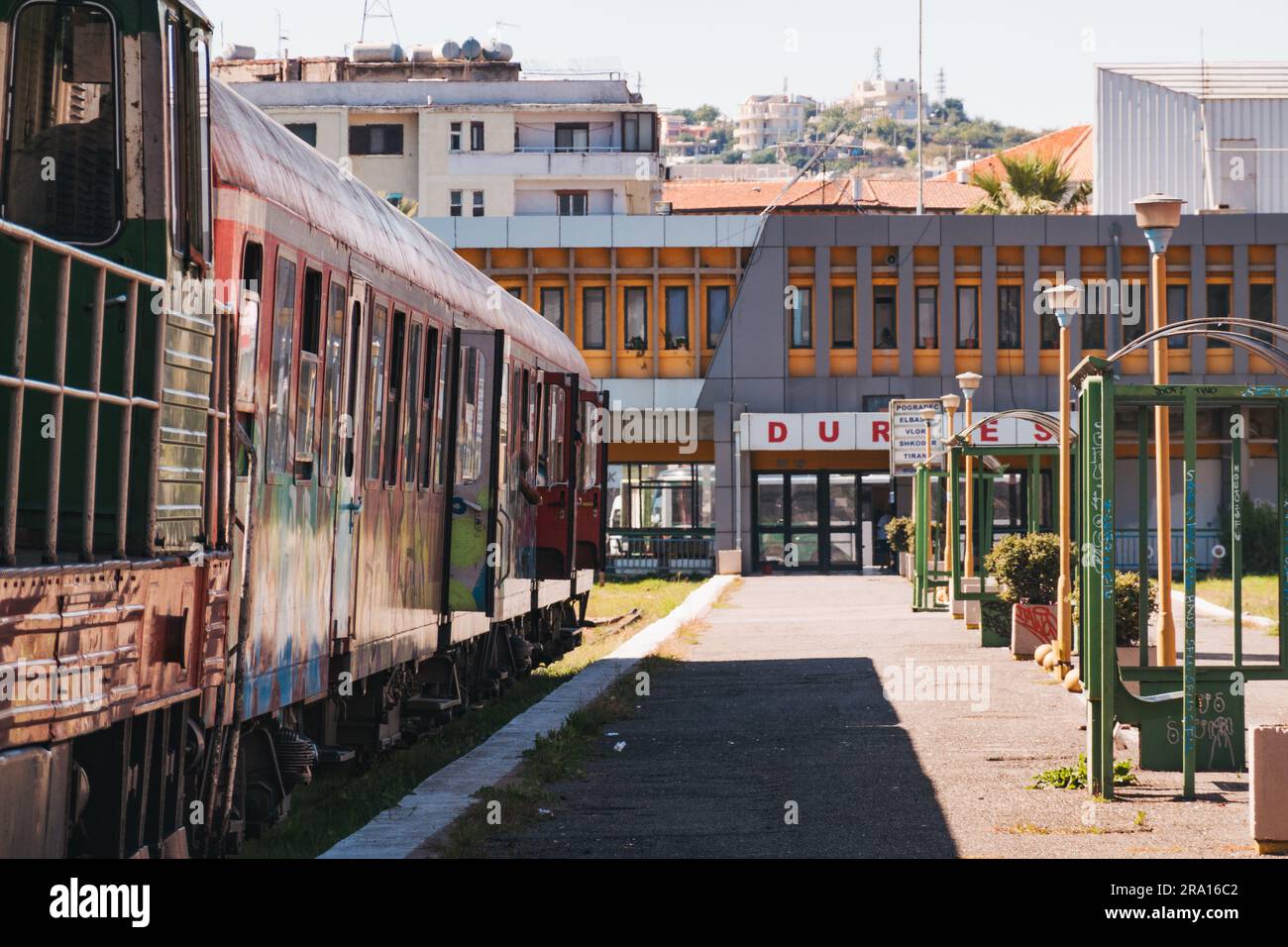 Diesel locomotives and old, graffiti-covered carriages wait to depart ...