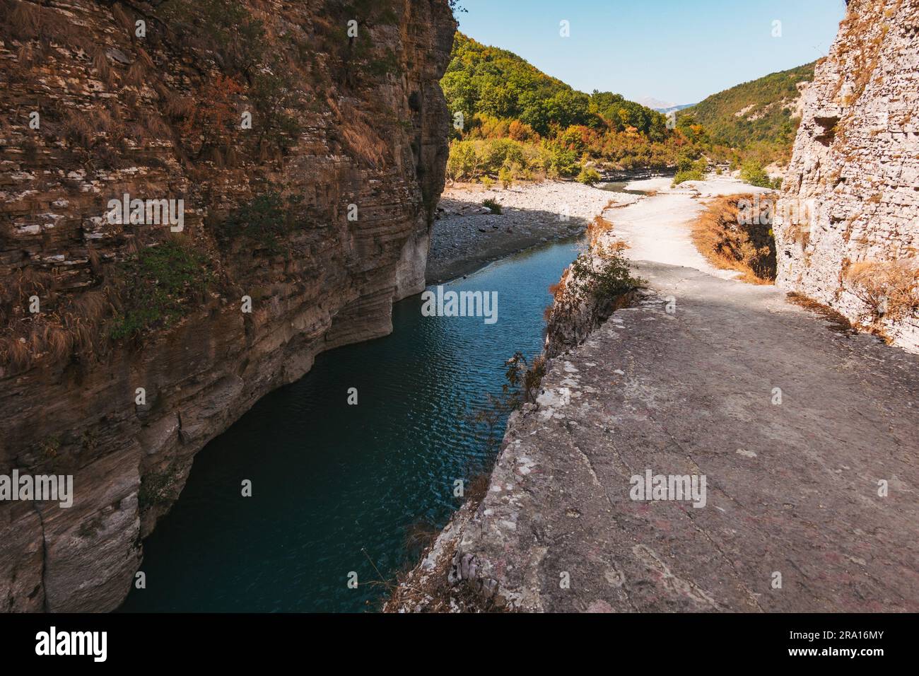 a walking trail along a canyon wall in Osumi Canyon, Berat County ...