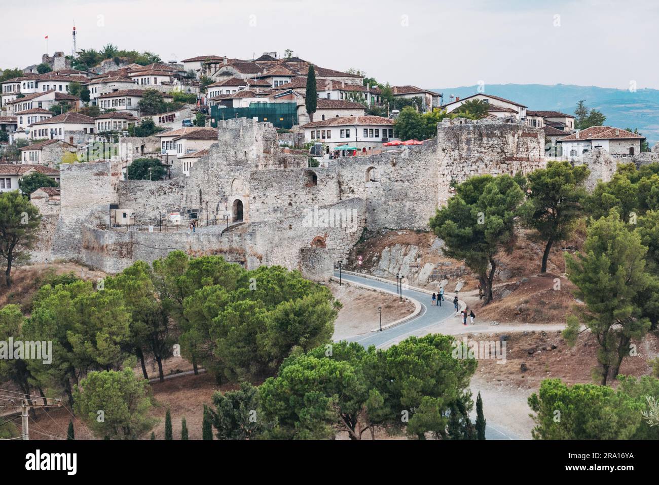 Looking at Berat Castle, a walled medieval city built atop a mountain ...