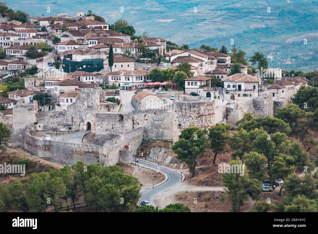 Looking at Berat Castle, a walled medieval city built atop a mountain ...