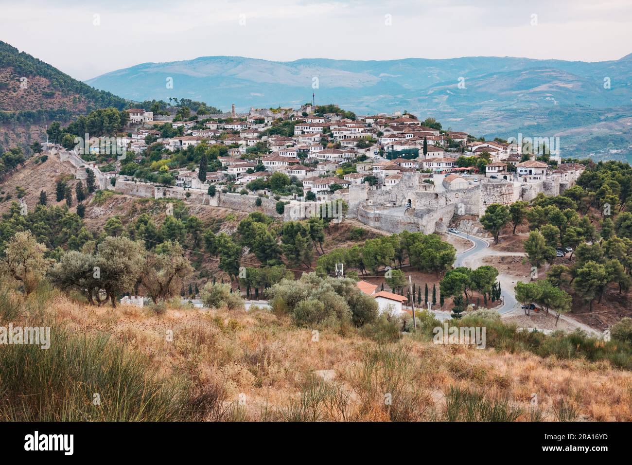Looking at Berat Castle, a walled medieval city built atop a mountain ...