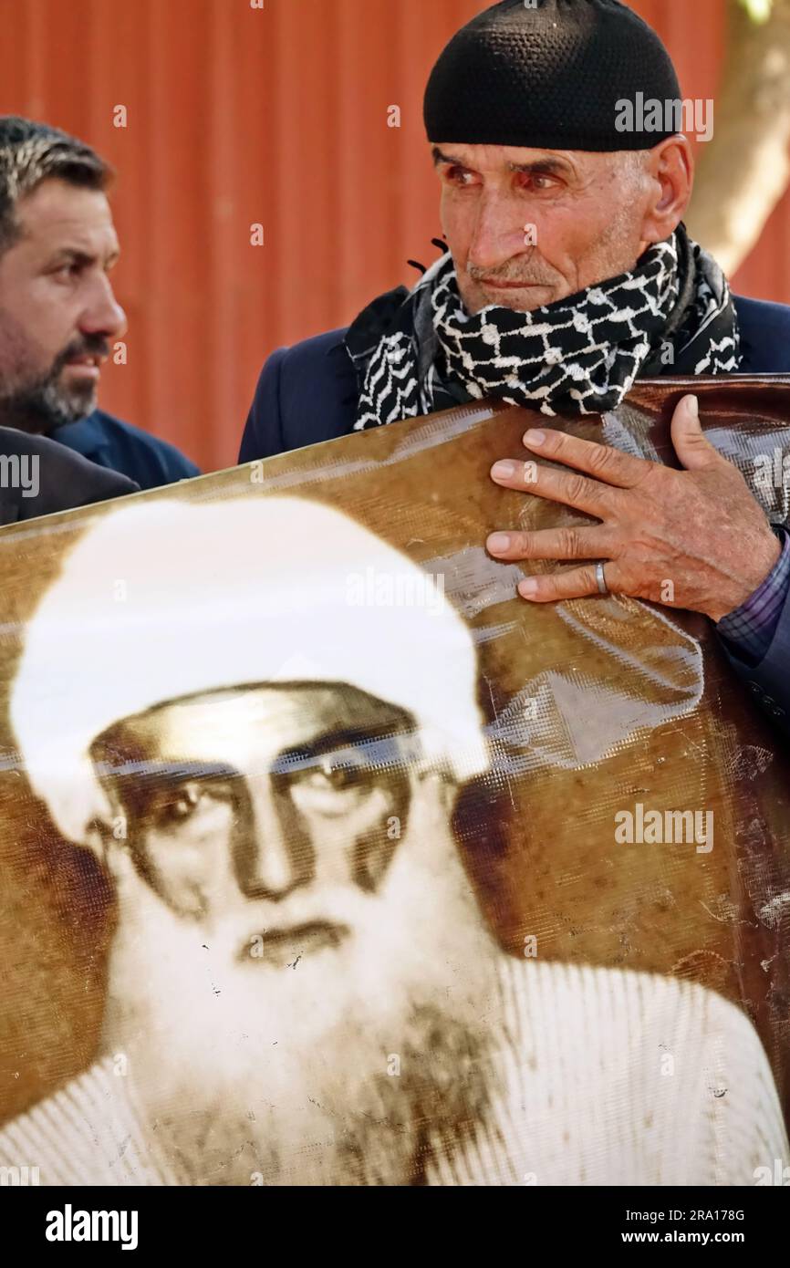 Participants hold a banner during the memorial ceremony for the Kurdish ...