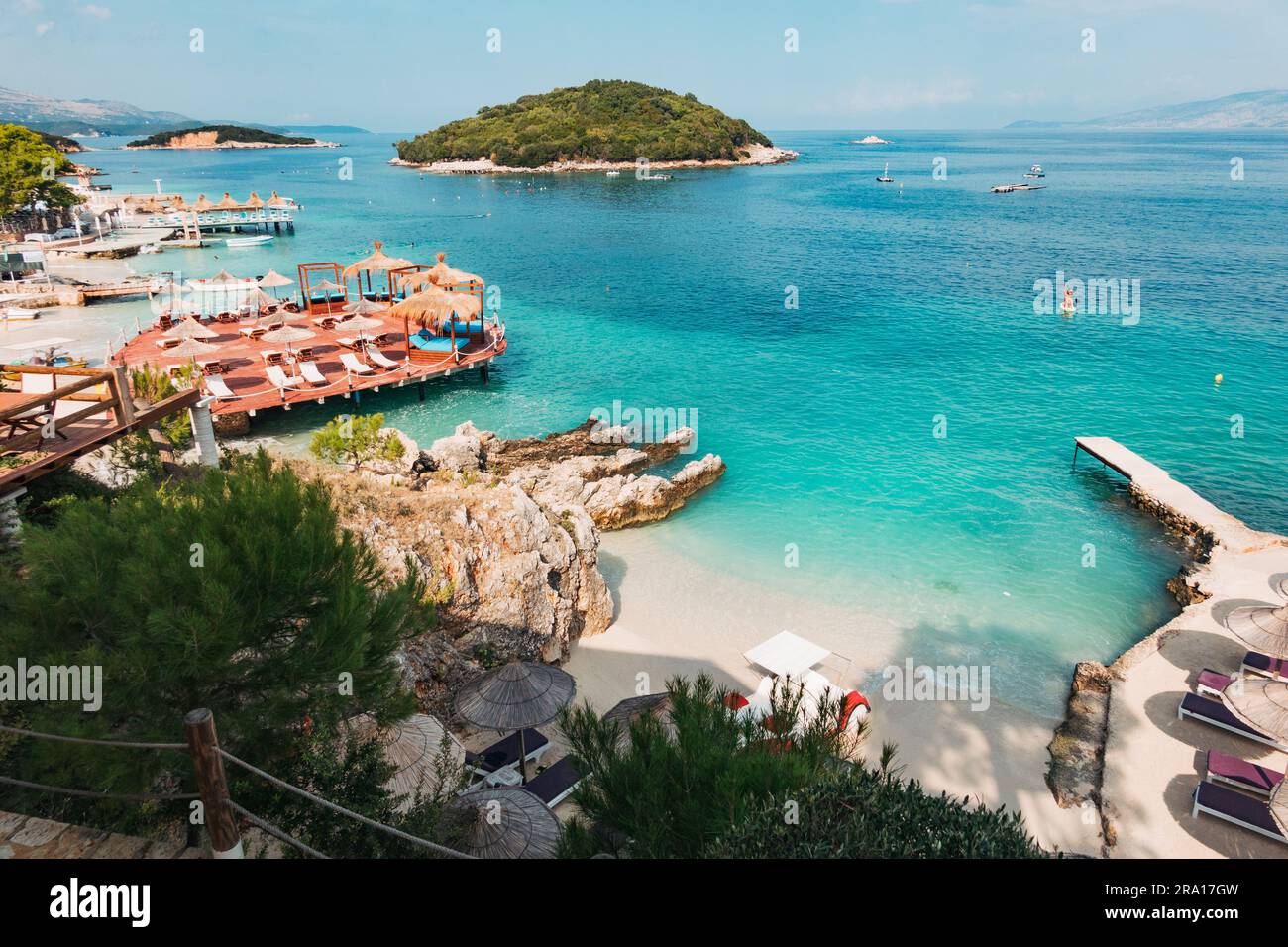 loungers, sun umbrellas and turquoise blue waters waiting for tourists ...