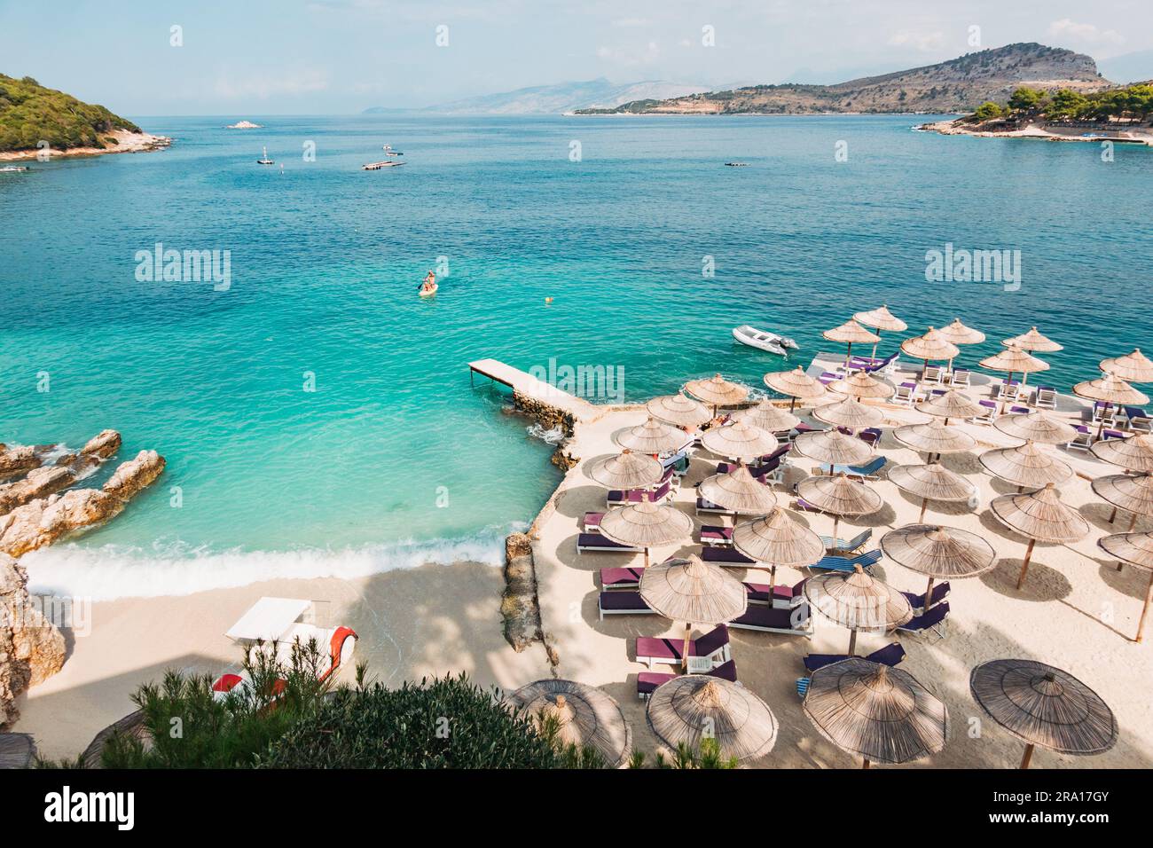 loungers, sun umbrellas and turquoise blue waters waiting for tourists ...
