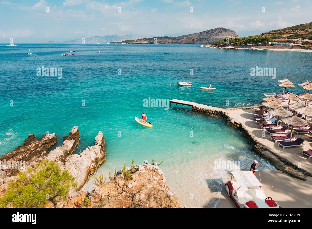 loungers, sun umbrellas and turquoise blue waters waiting for tourists ...