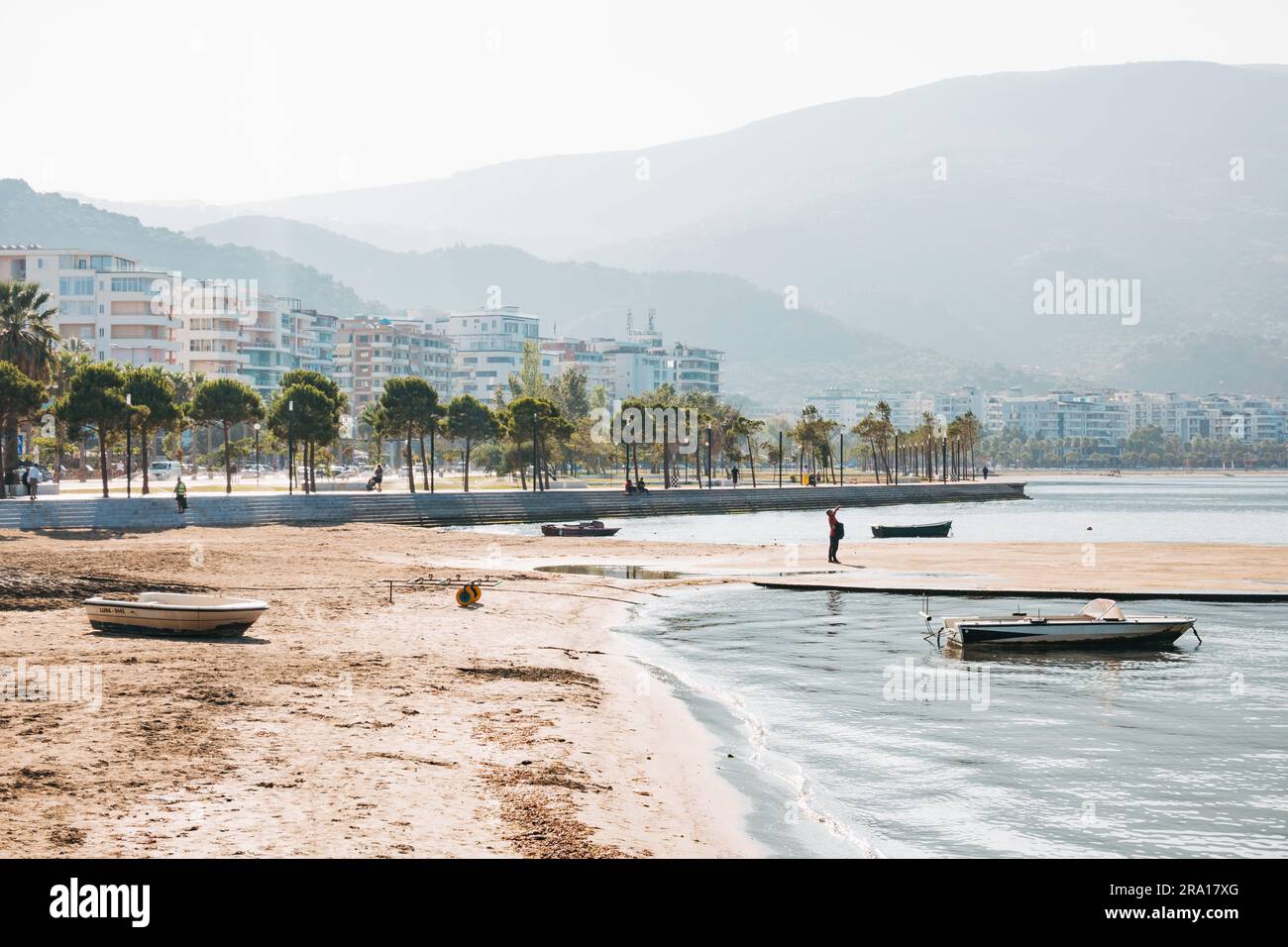small boats in the bay in the coastal city of Vlorë, in southern ...