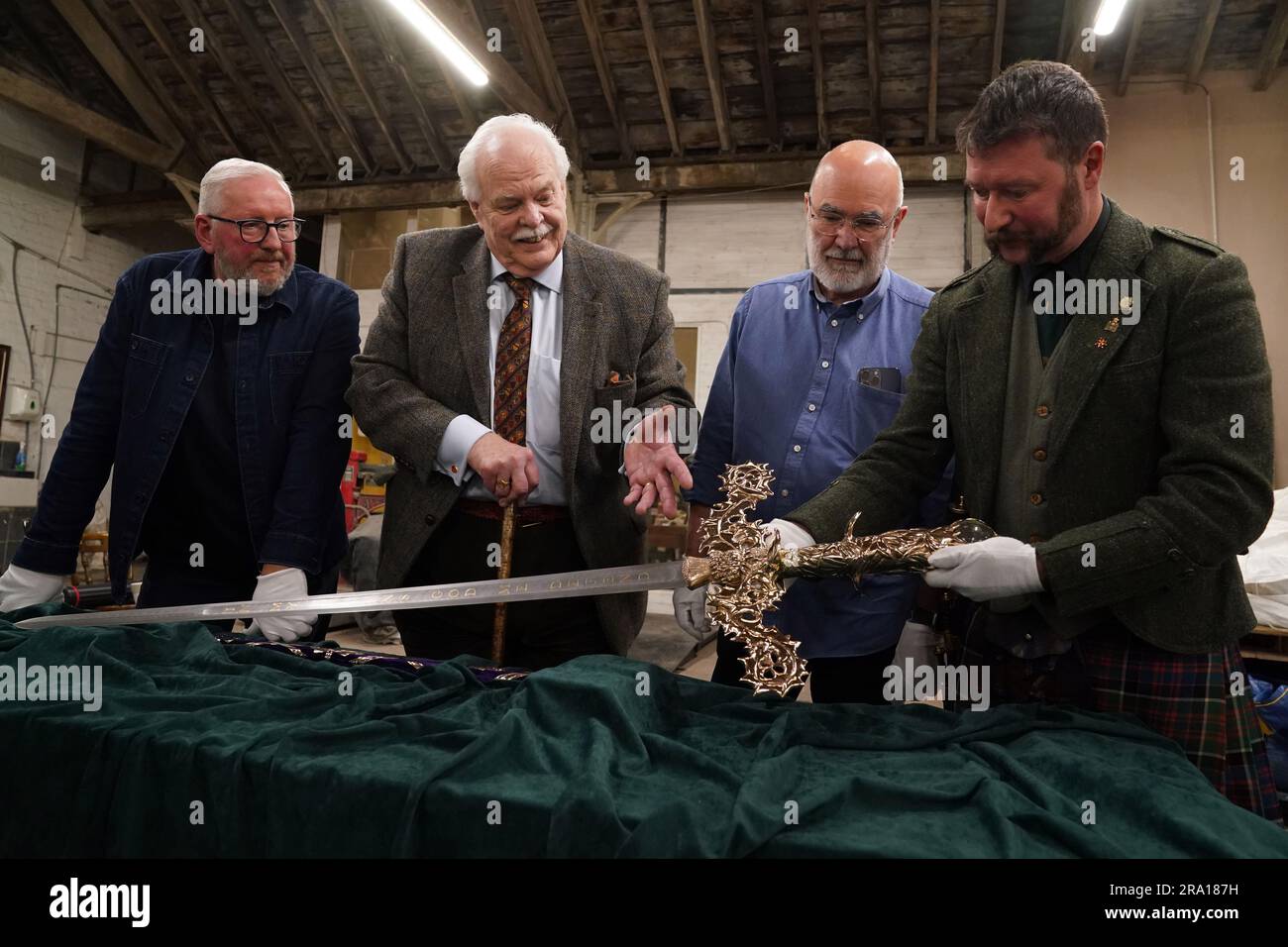 Sword designer Mark Dennis (second left) with his team Alan Herriot ...
