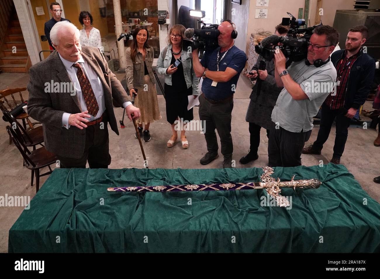 Sword designer Mark Dennis (left) views The Elizabeth sword which will ...