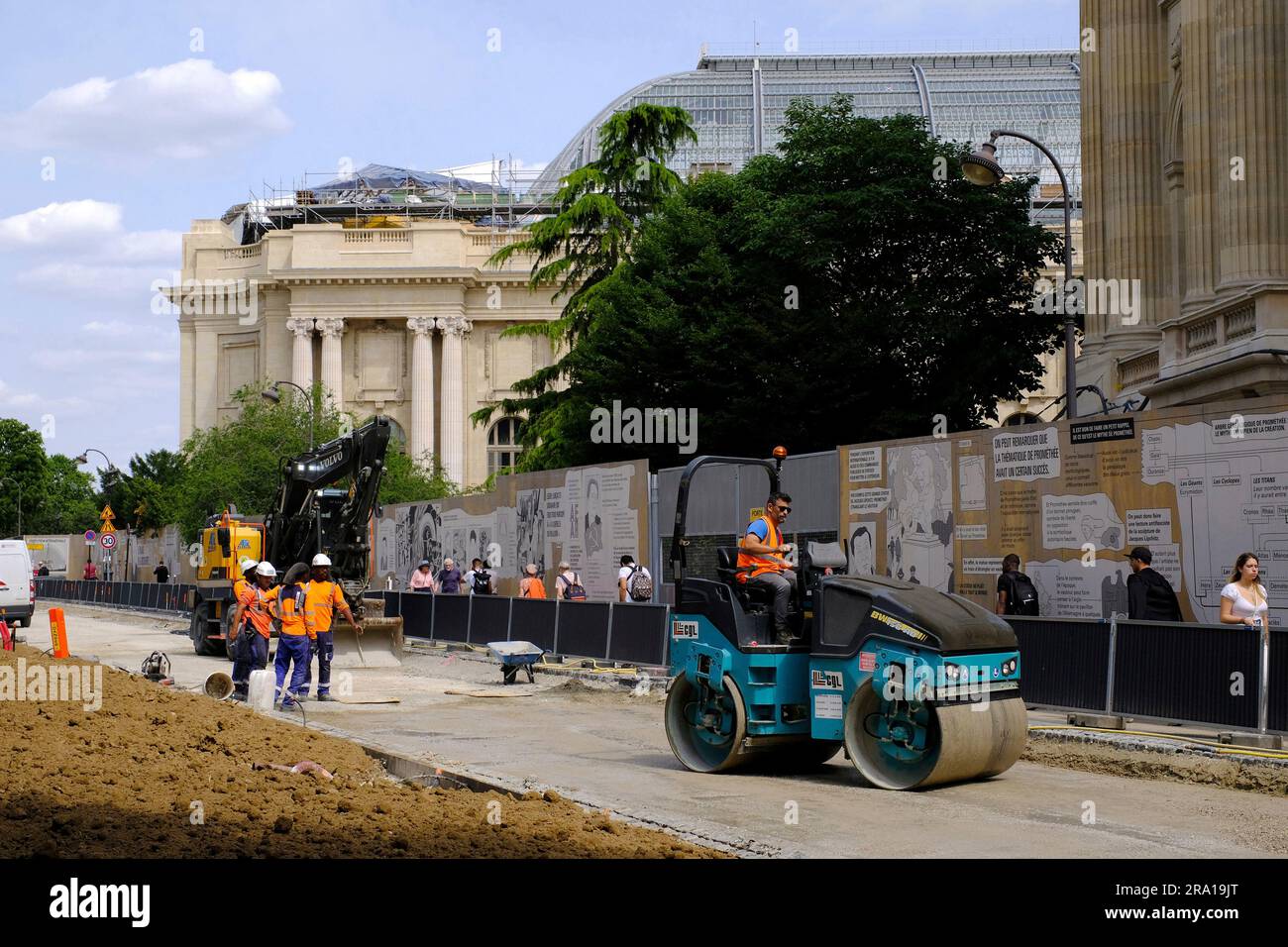 Construction workers pave the road near the Grand Palais in Paris on ...