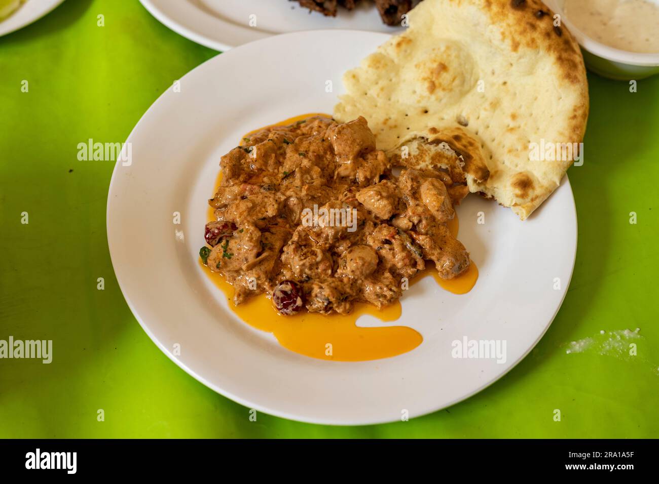 Chicken handi serving in a plate with nan piece closeup Stock Photo - Alamy