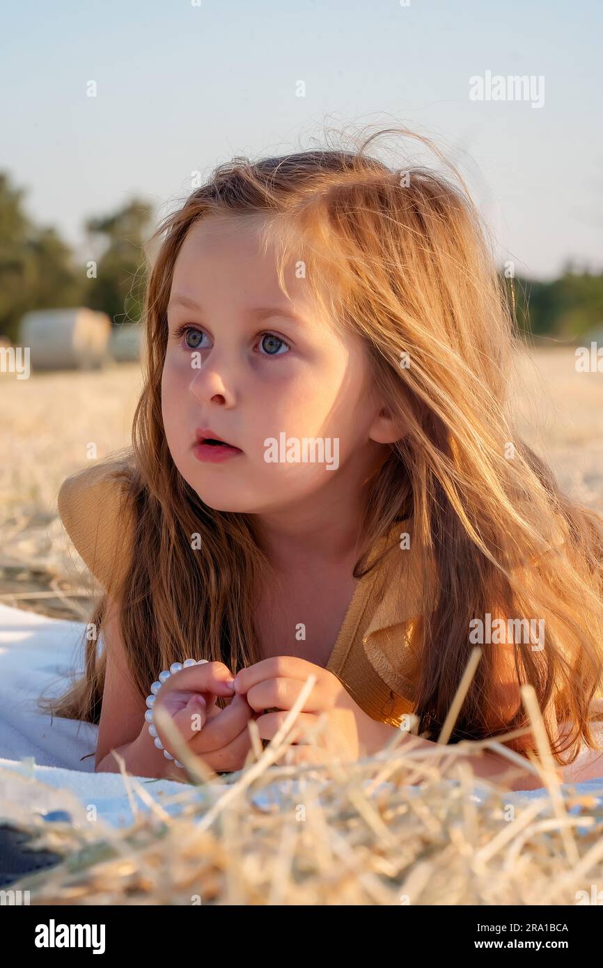 Portrait of a cute girl lying with her hair loose in the sun. Summer nymph Stock Photo - Alamy