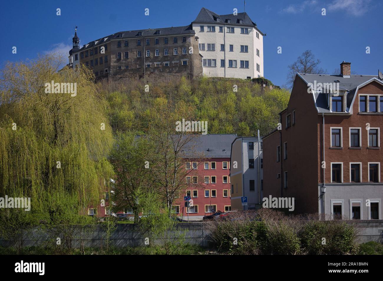 The historic von Reuss castle on a hillside, surrounded by lush green ...