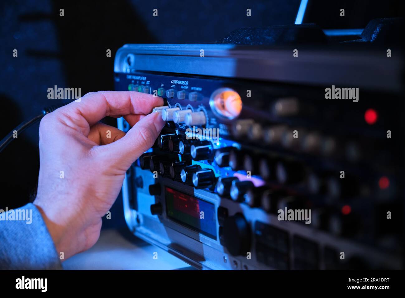 Close up of a musician hand adjusting the sound with mixing console ...