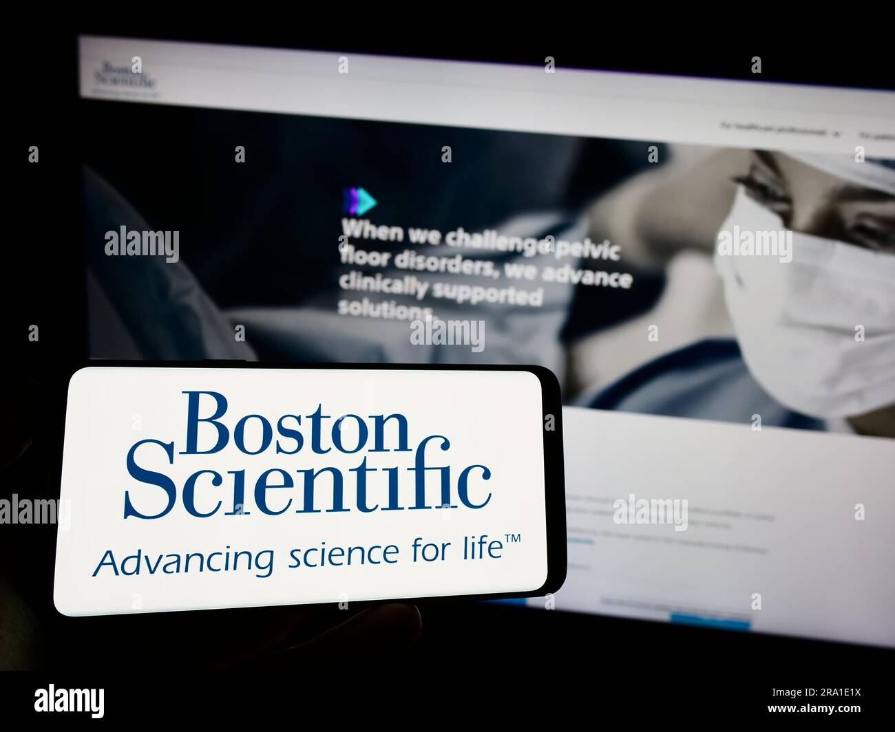 Person holding mobile phone with logo of American company Boston ...