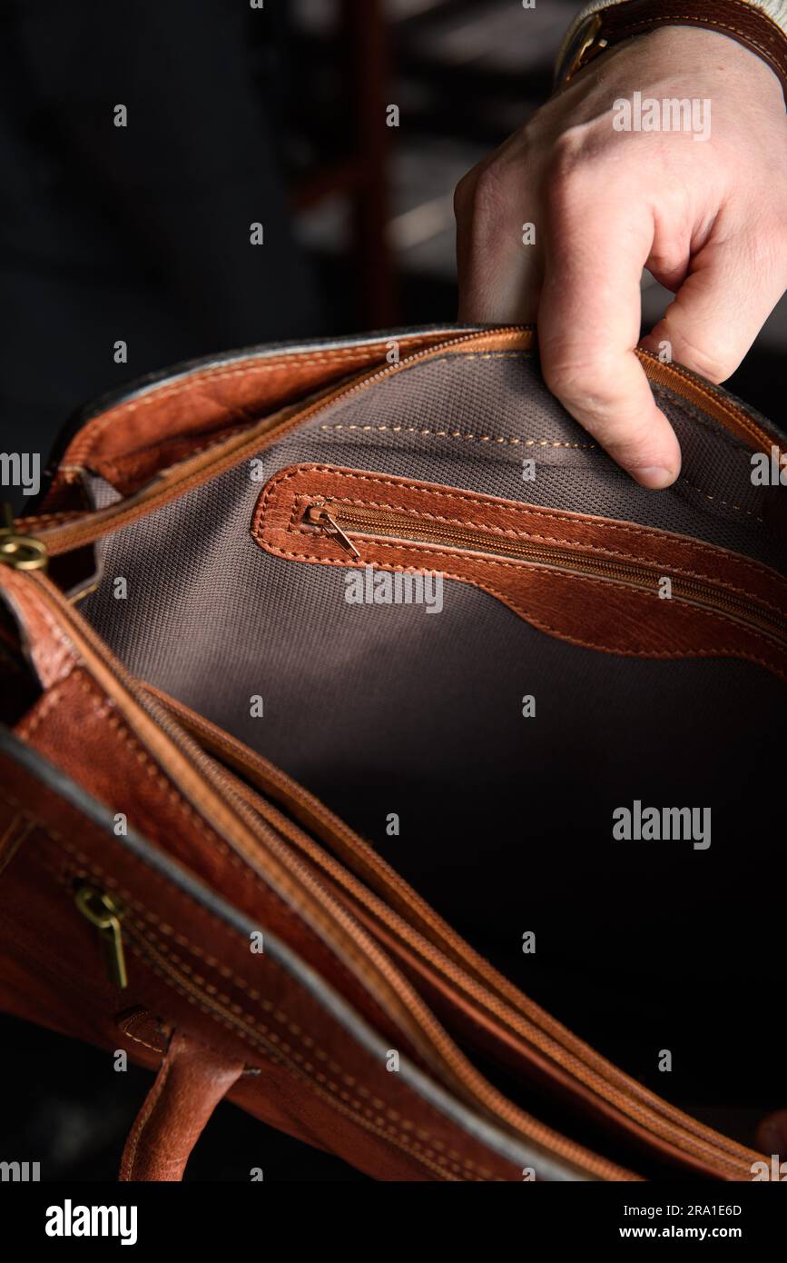 top view of open empty leather bag in mans hands Stock Photo - Alamy