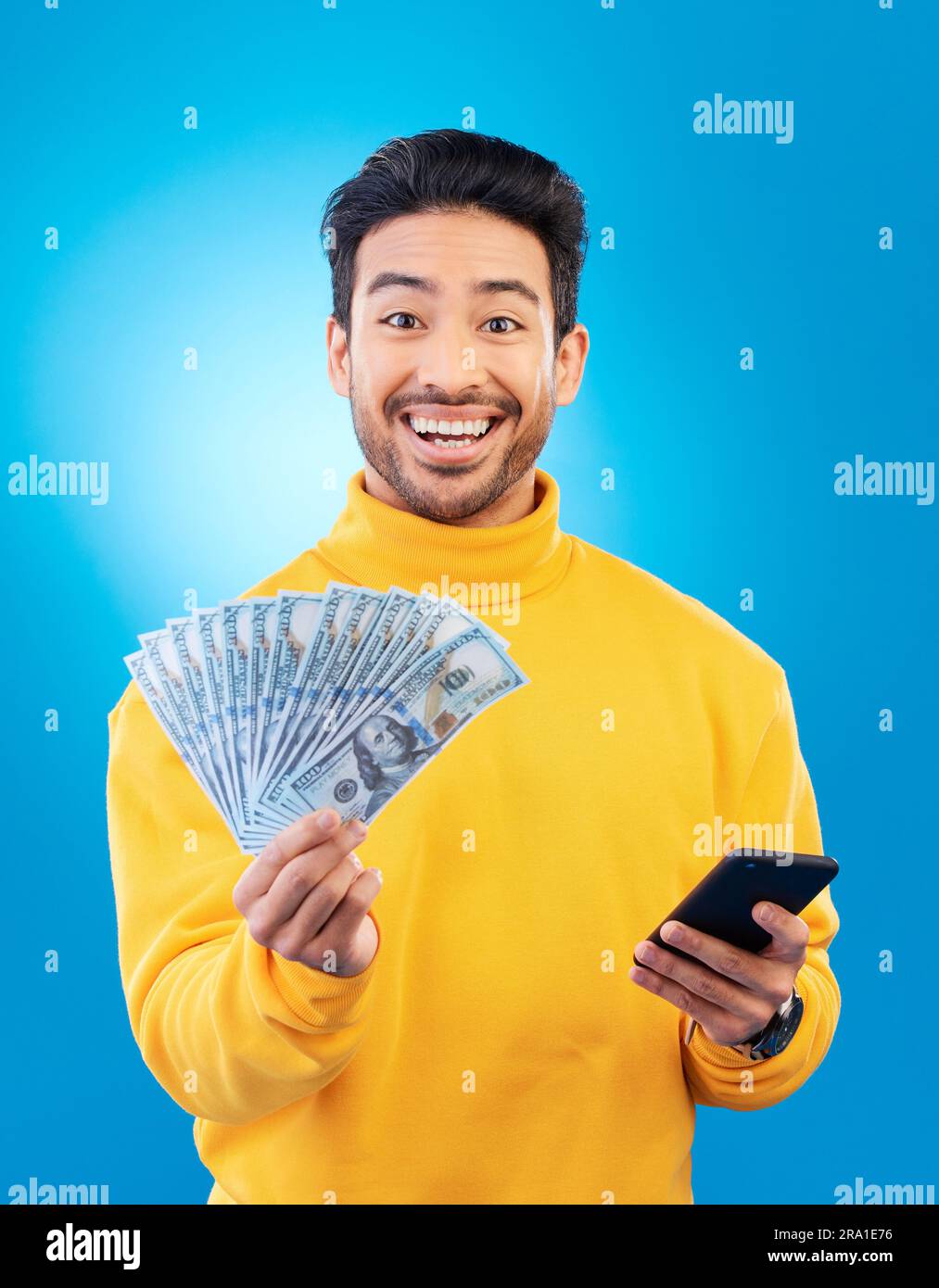 Man, phone and cash fan in studio for prize, esports gambling or ...