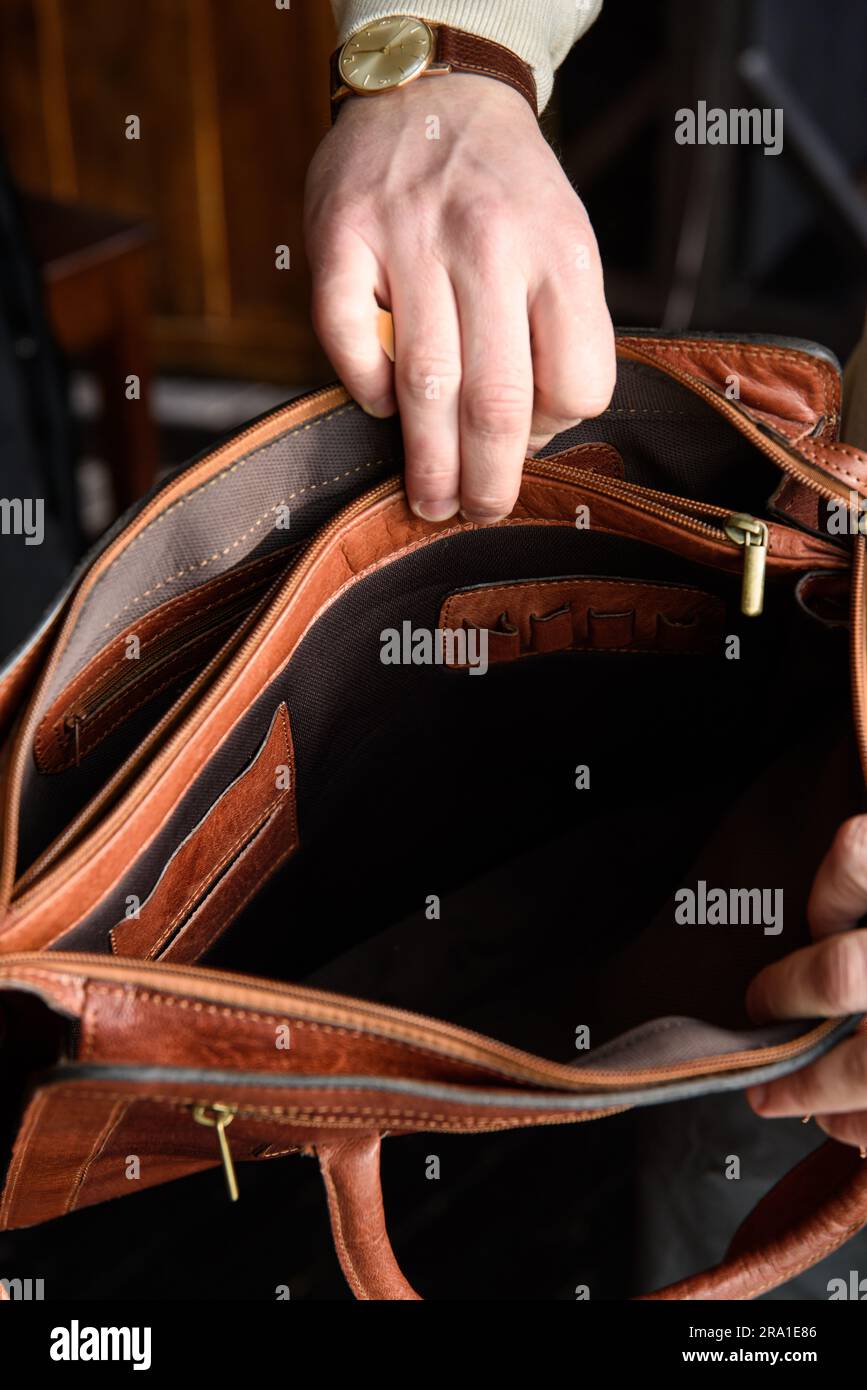 top view of open empty leather bag in mans hands Stock Photo - Alamy