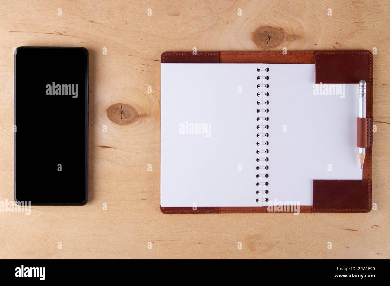 Digitalization concept. Paper notebook vs smartphone. Digital phone ...